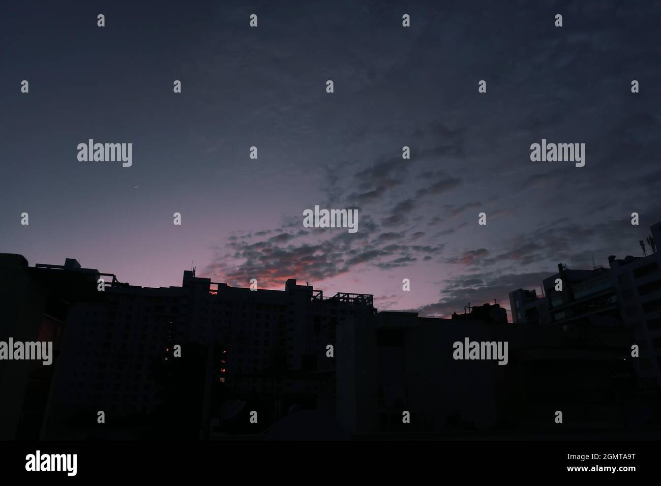 sunset over the building of a city Stock Photo - Alamy