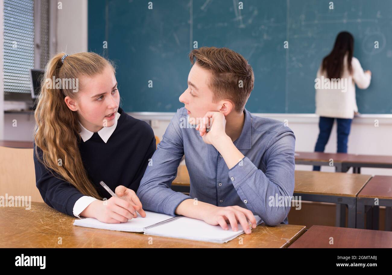 Girl explaining lesson to boy Stock Photo - Alamy