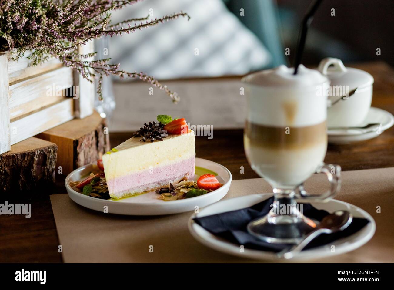 Peace of apricot cake with cup of latte macchiato Stock Photo - Alamy