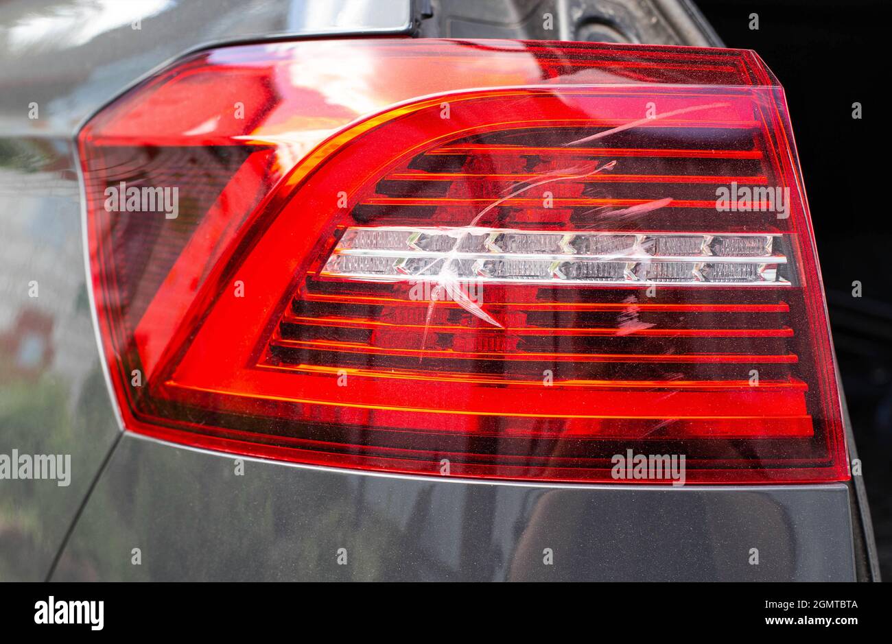 Rear car lamp with a crack. Damage to the stop lamp, accident. Dent ...