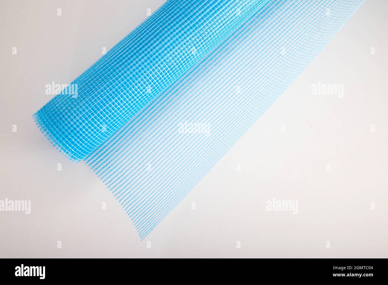 Blue reinforcing construction mesh for wall strengthening on white ...