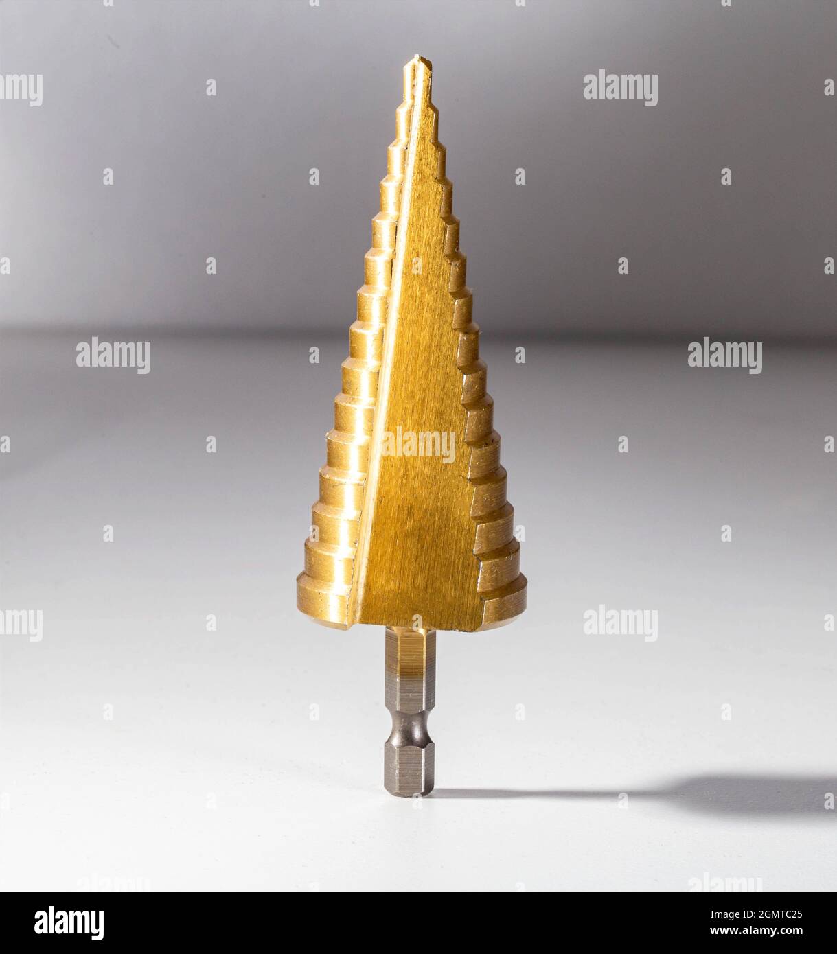 Gold step drill for drilling holes of different diameters, close-up ...