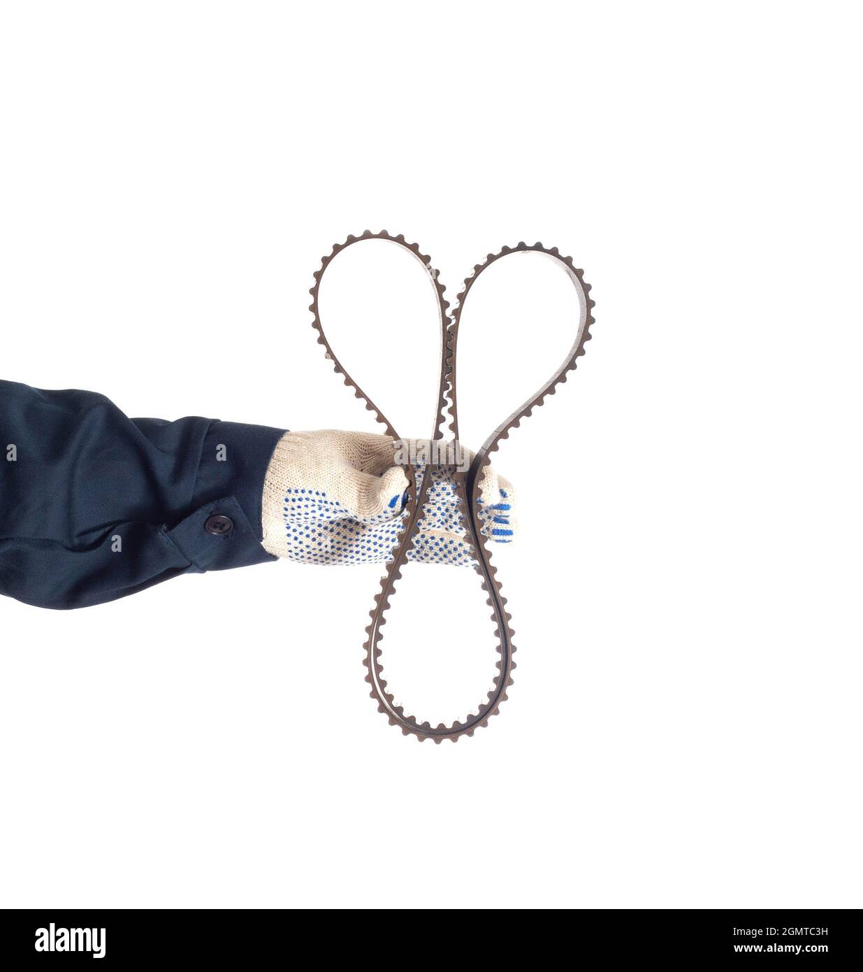 Auto locksmith holding a used timing belt on a white background ...