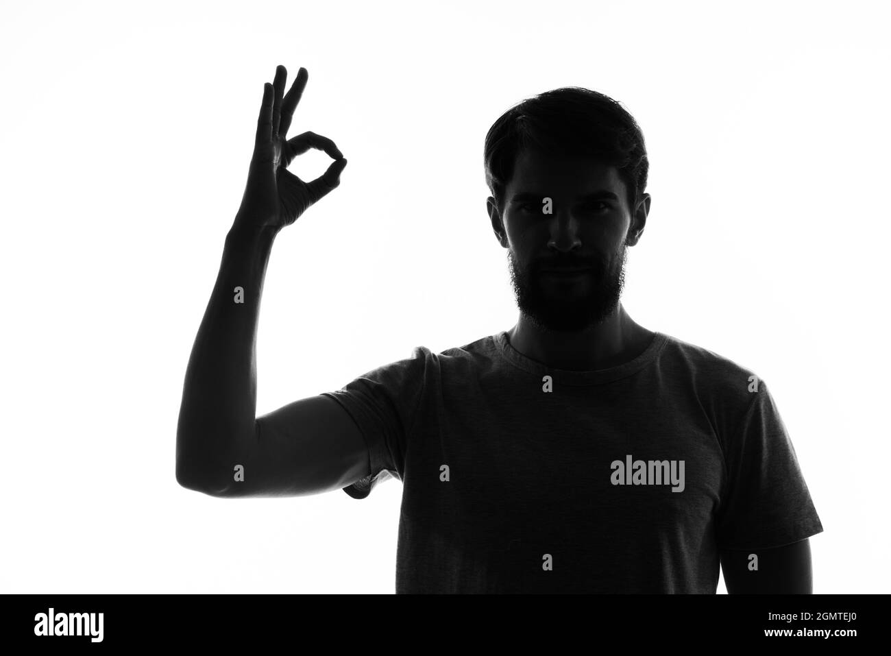 The man in a suit with a pistol in hand crime hand gesture posing ...