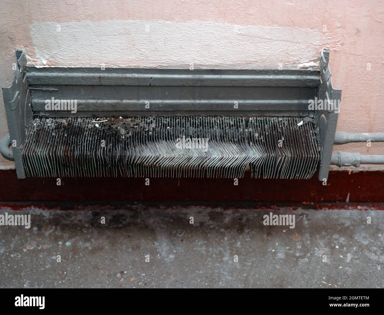 Old damaged central heating radiator mounted on a wall, high resolution ...