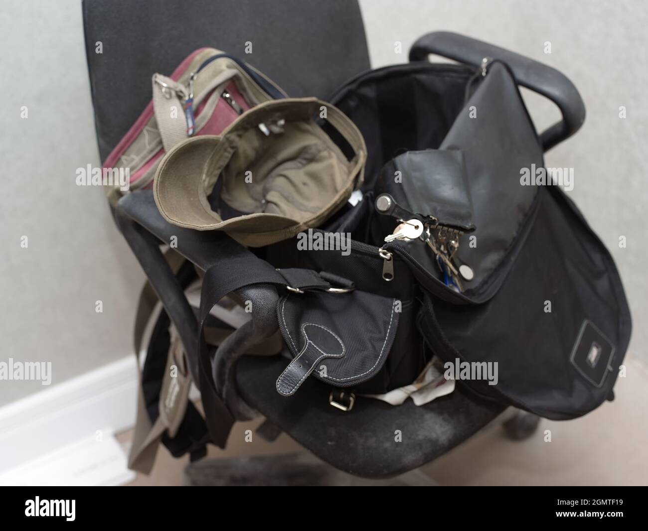 A pile of personal effects abandoned on a chair, indoor close up ...