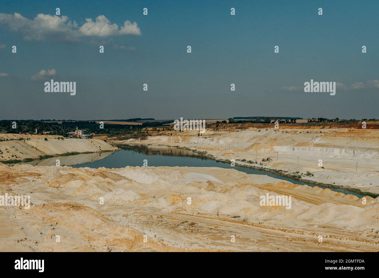 Sand quarry. Turquoise lagoon and surface mine with exposed colored ...