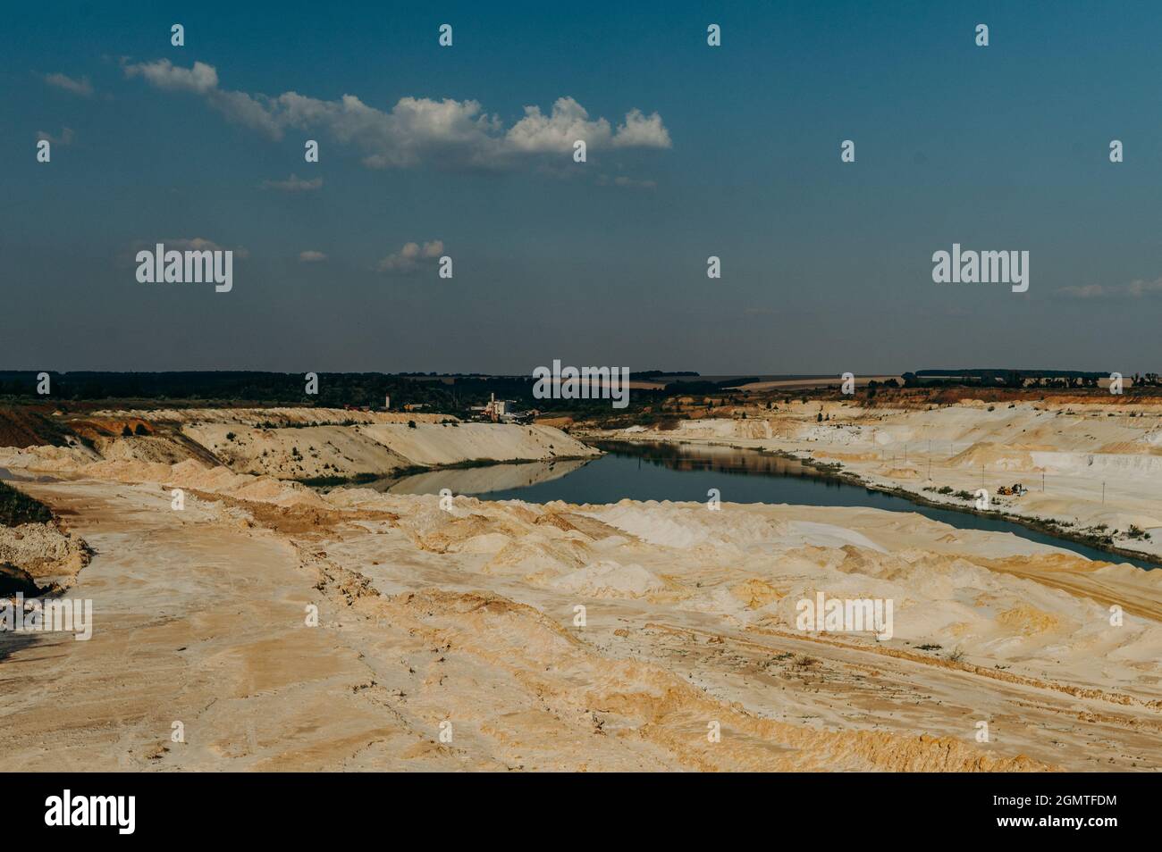 Sand quarry. Turquoise lagoon and surface mine with exposed colored ...