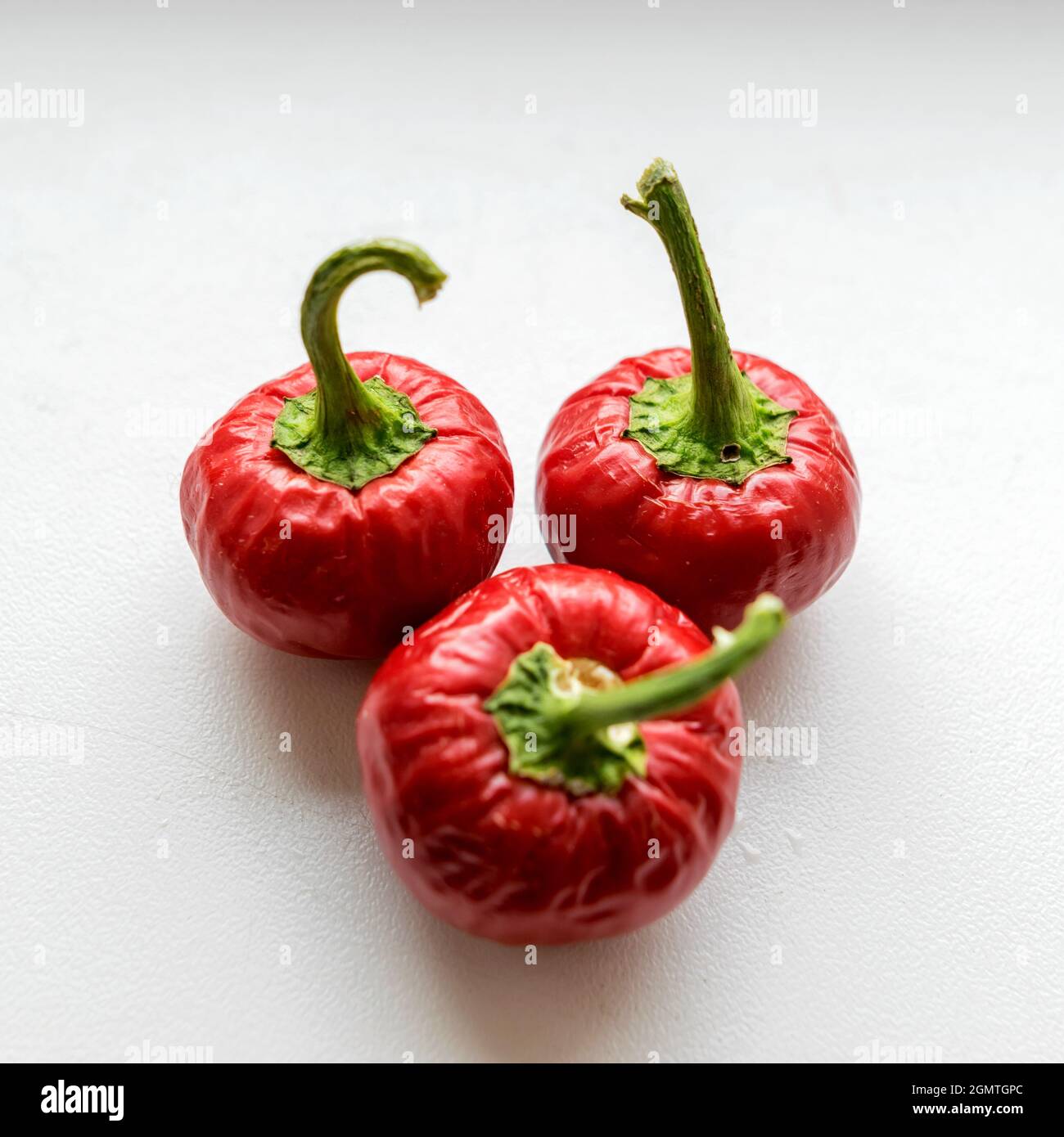 beautiful red mini peppers on a light background, suitable for ...