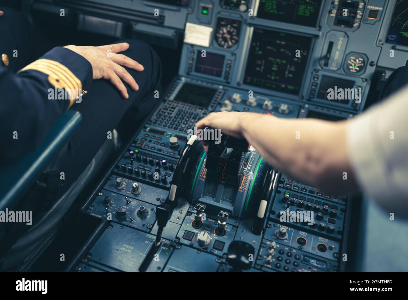 Pilot's hand accelerating on the throttle in a commercial airliner ...