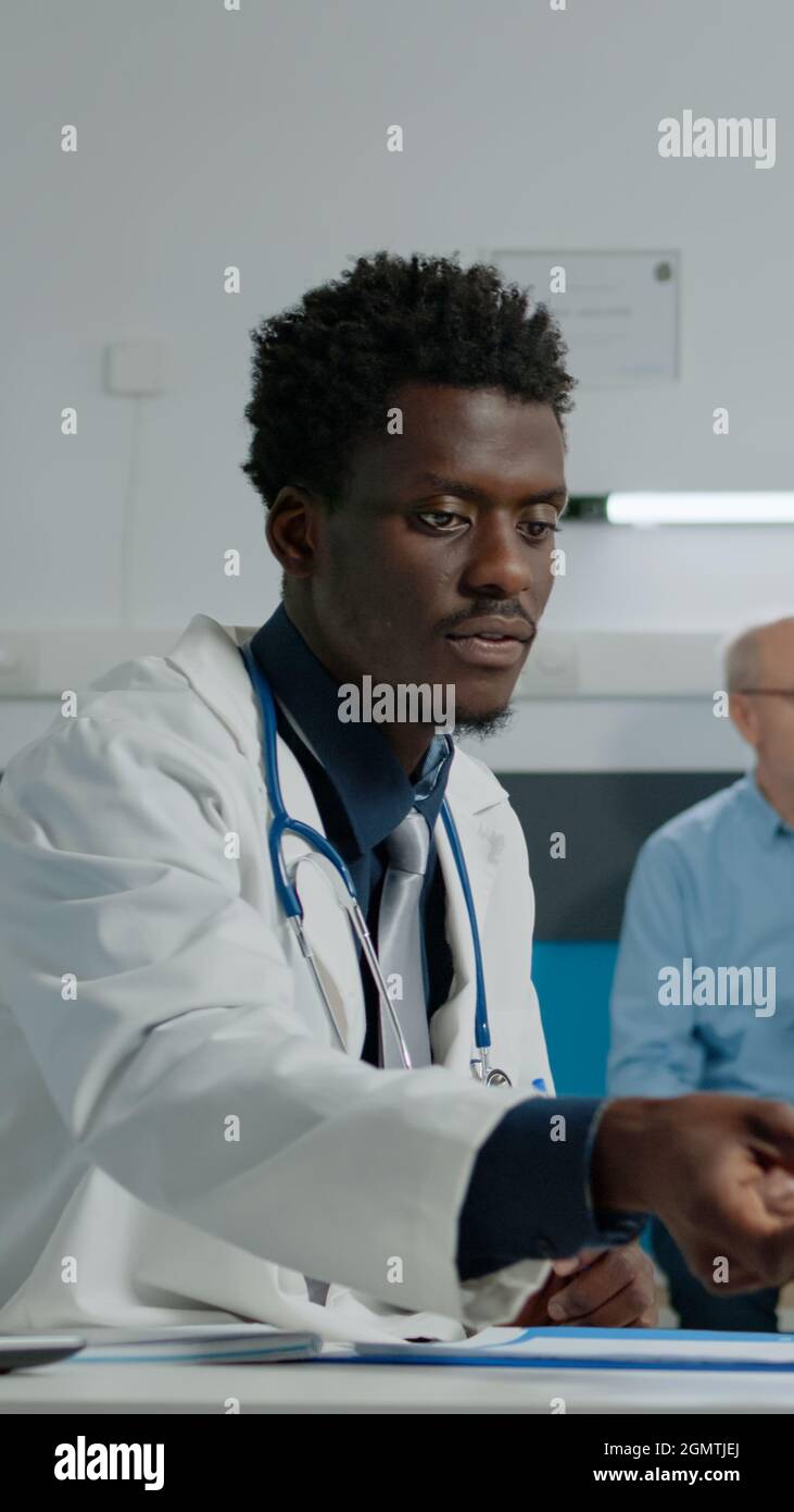 Doctor giving patient documents hi-res stock photography and images - Alamy