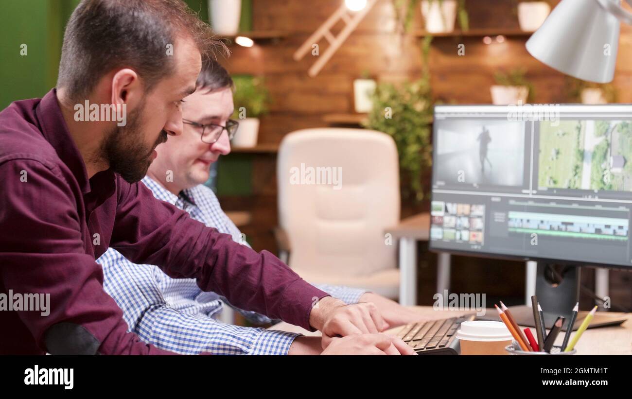 Videographer producer man editing film footage discussing visual ...