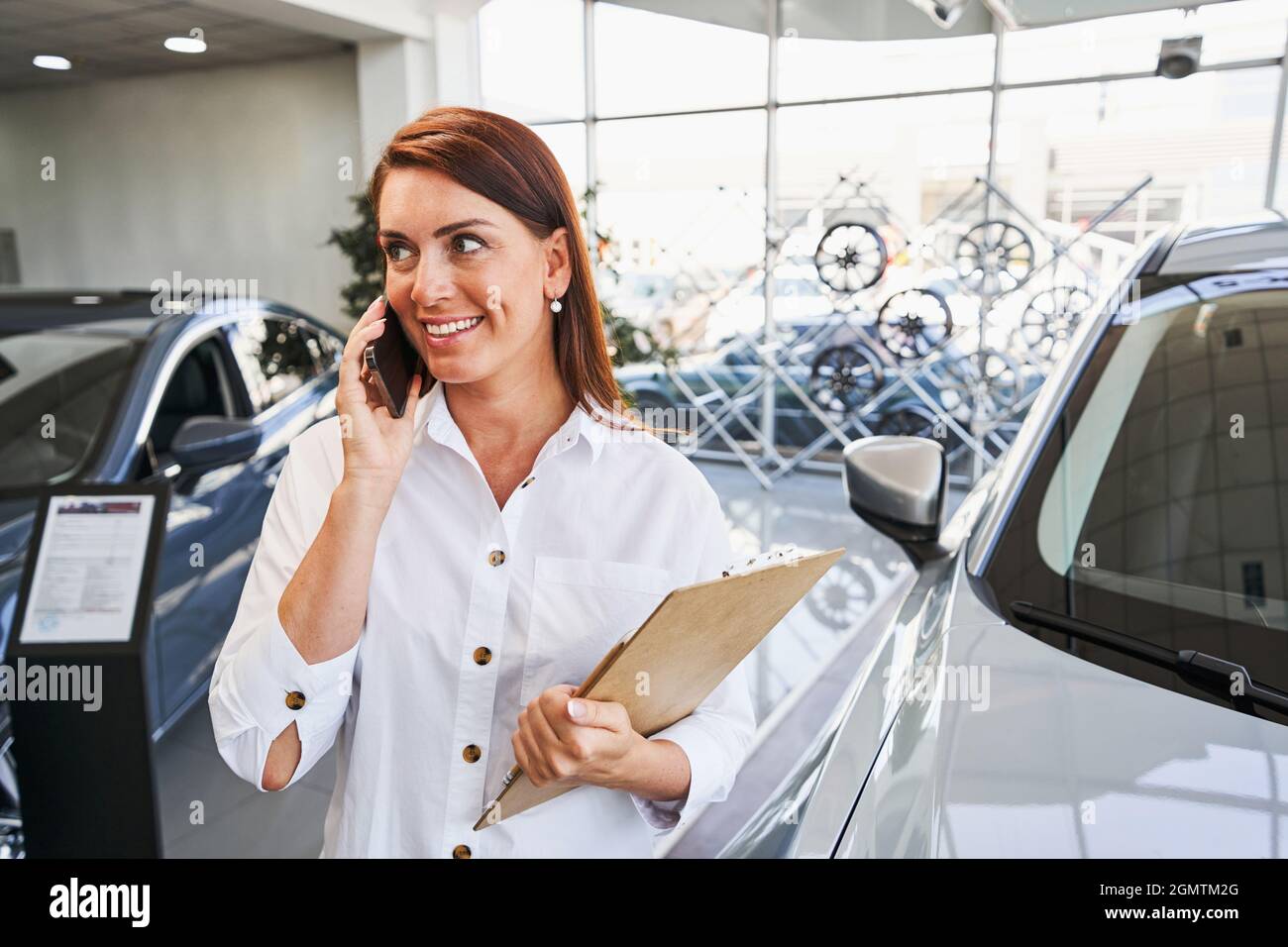 Busy day for the worker of luxurious car dealership Stock Photo - Alamy