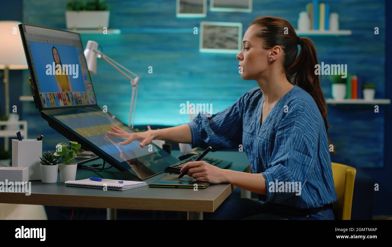 Image editor doing retouch work on touch screen computer using editing ...