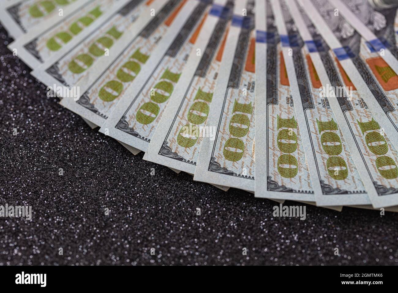 fan of 100 dollar banknotes on black glitter background Stock Photo - Alamy