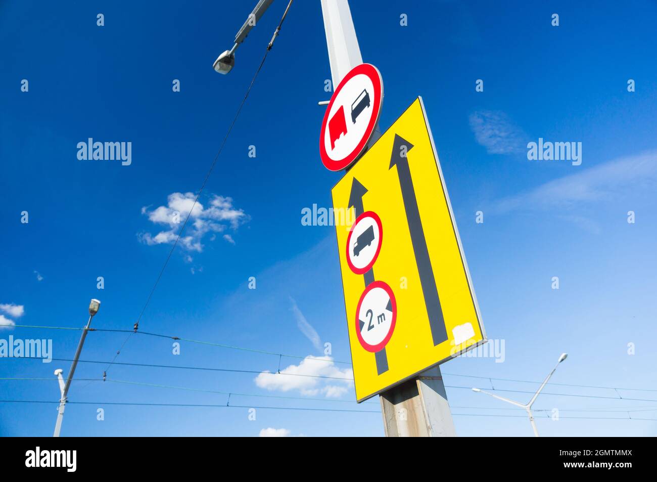 Traffic signs on a street lamp against the blue sk Stock Photo - Alamy