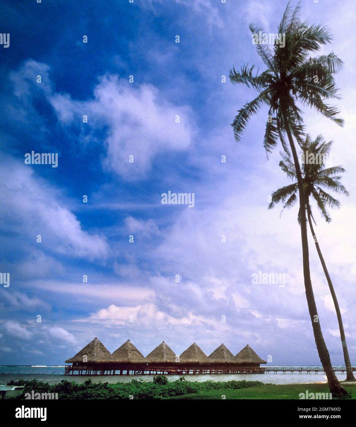 Tahiti, French Polynesia - March 1984; A line of beach huts by the ...