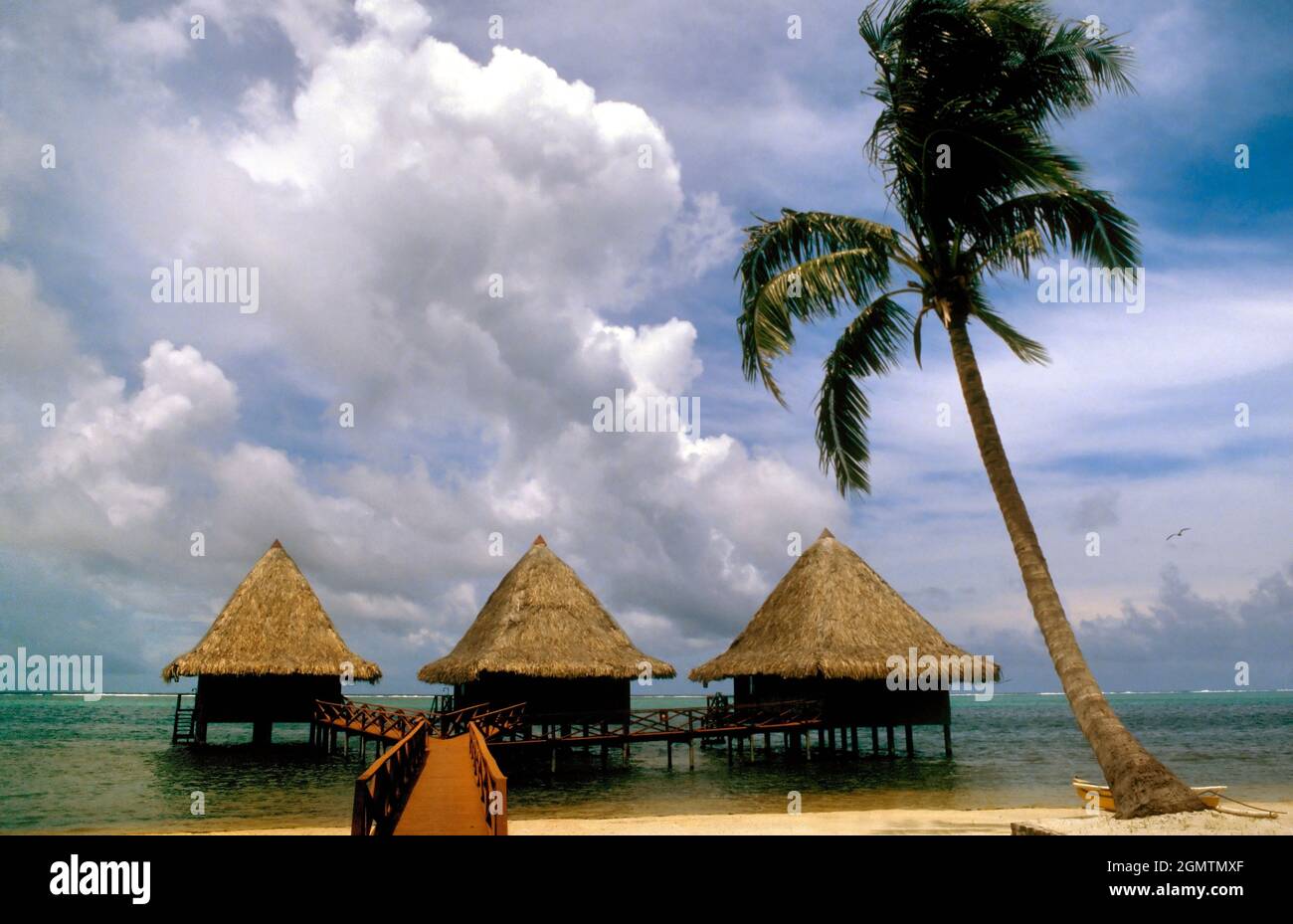 Tahiti, French Polynesia - March 1984; A line of beach huts by the ...