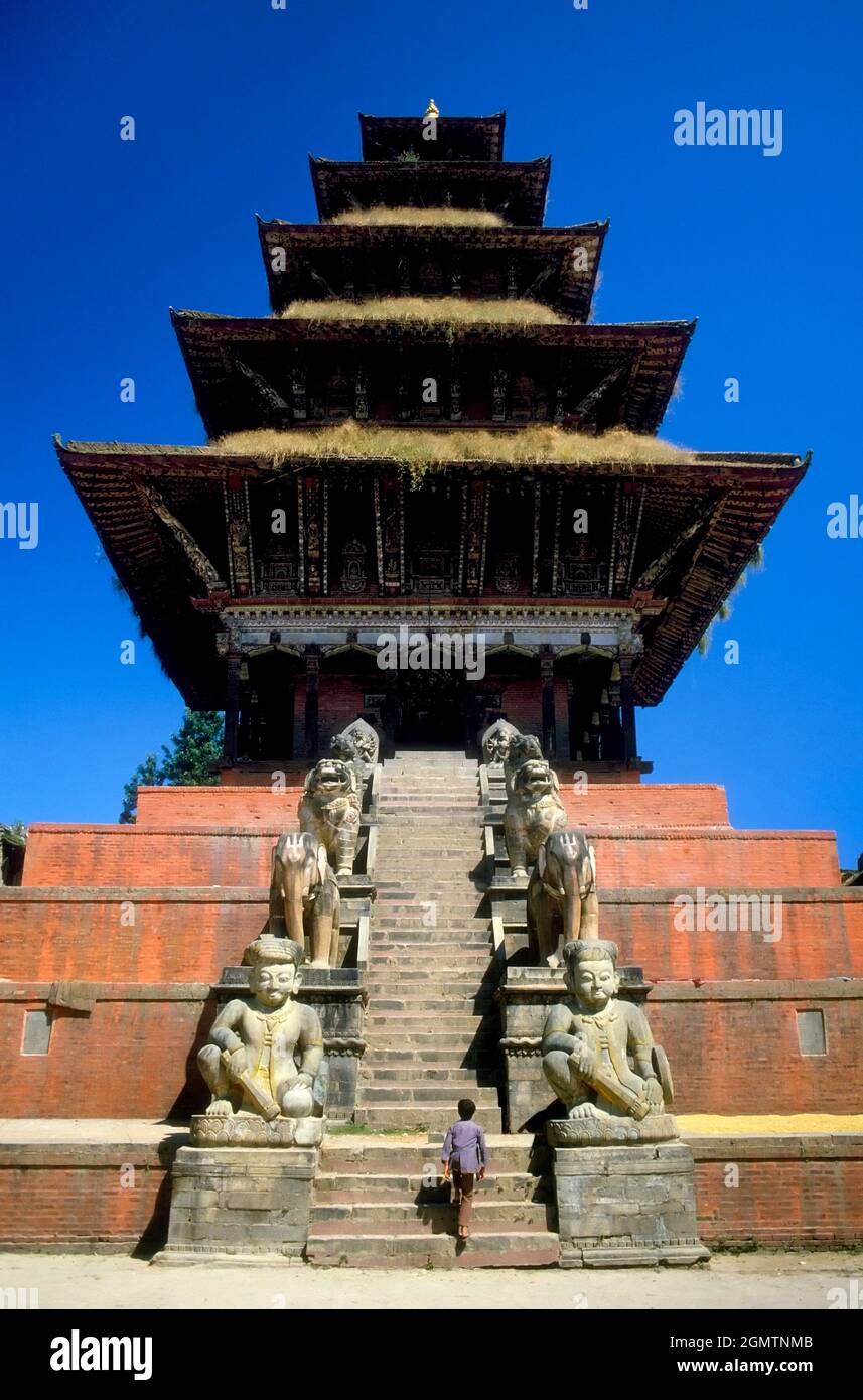 Pataan, Nepal - October 1984; A boy climbs the steps of a Hindu stupa ...