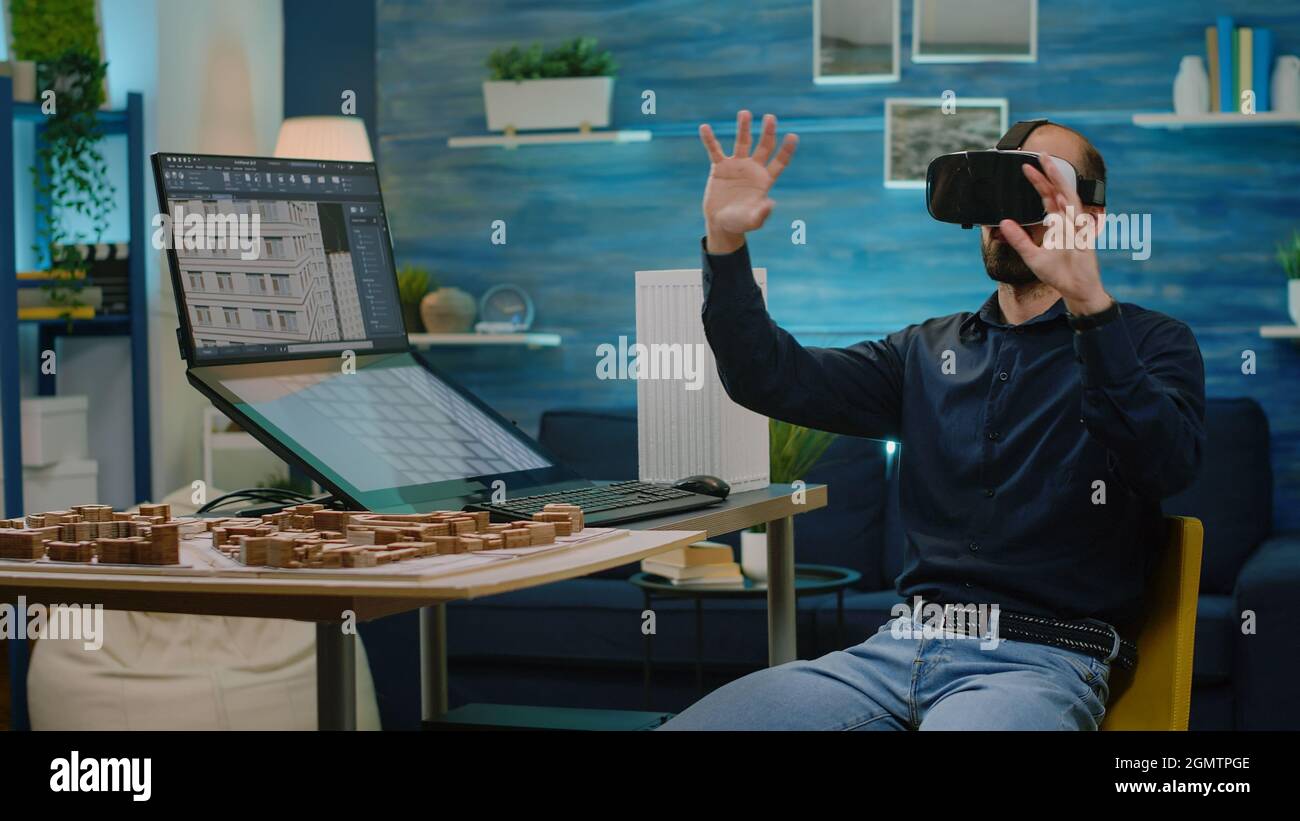 Architect using vr glasses for building model design in architectural ...