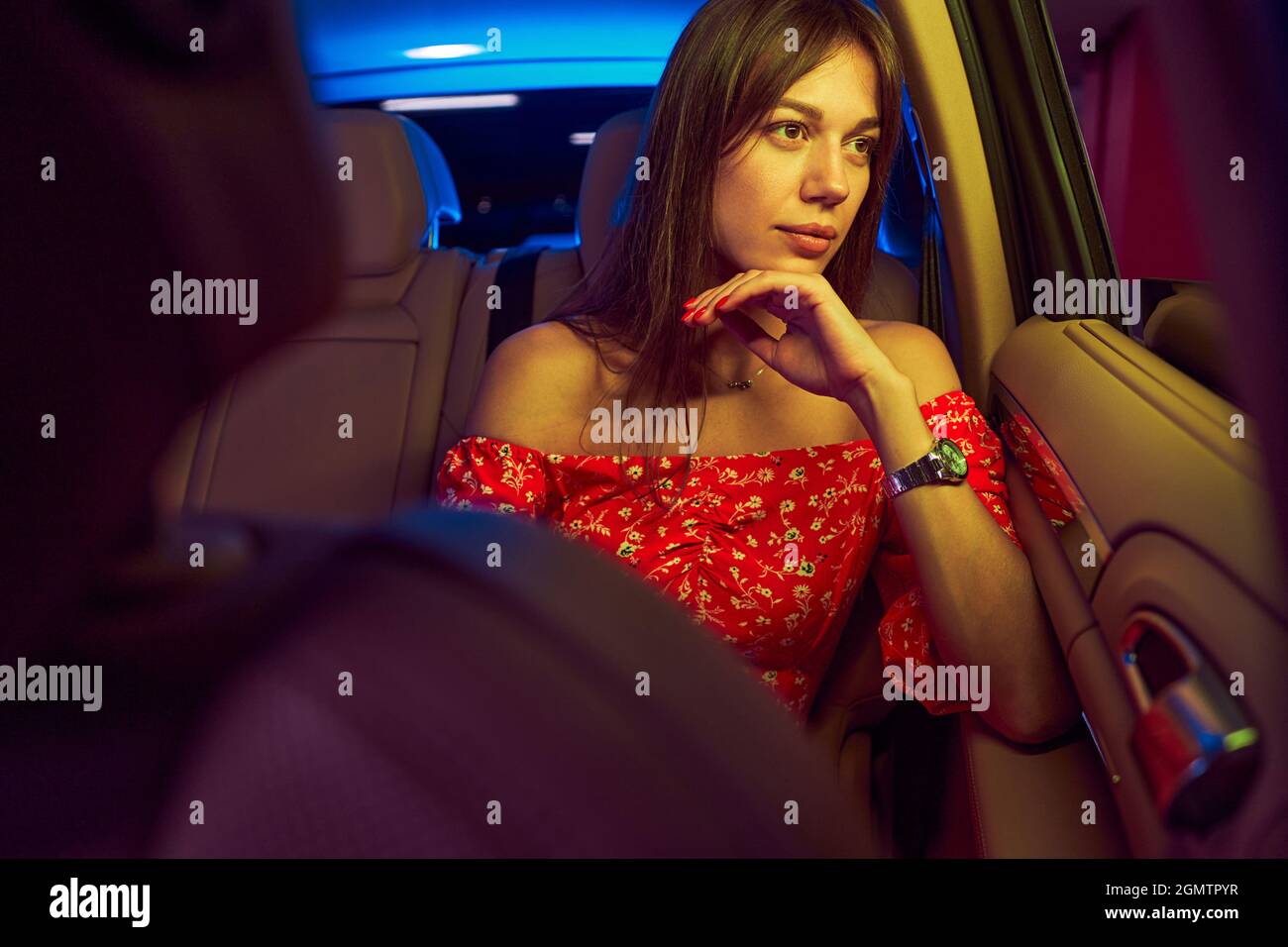 Woman sitting on back seat in automobile Stock Photo - Alamy