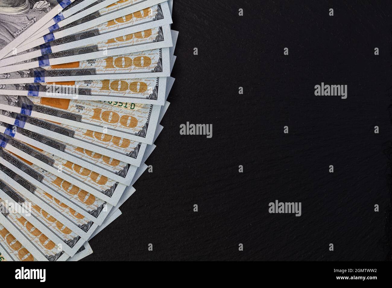 fan of 100 dollar banknotes on black glitter background Stock Photo - Alamy