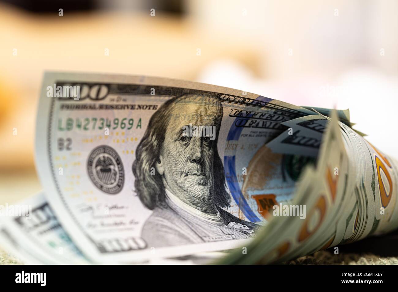 fan of 100 dollar banknotes on black glitter background Stock Photo - Alamy
