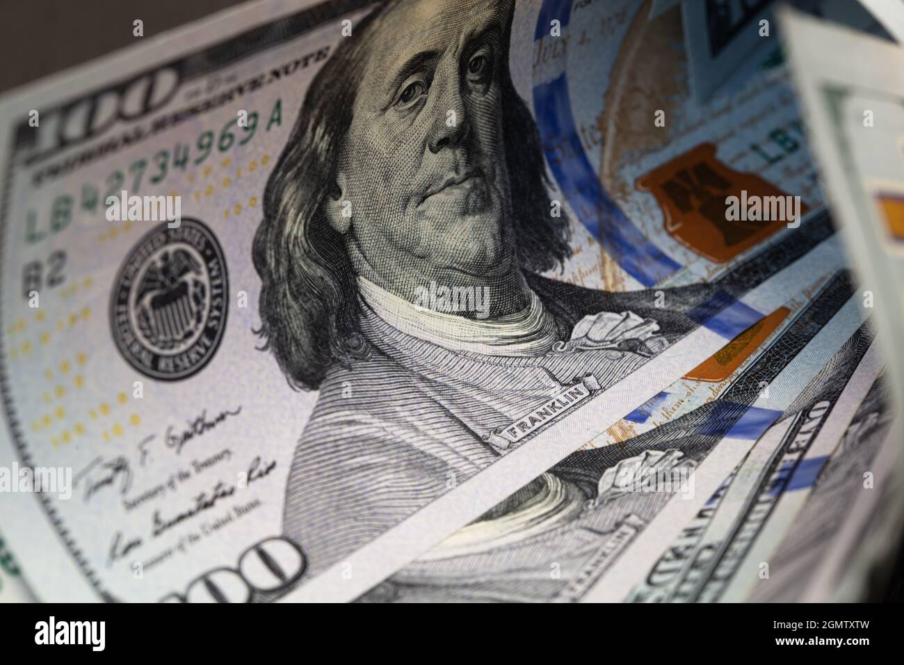 fan of 100 dollar banknotes on black glitter background Stock Photo - Alamy