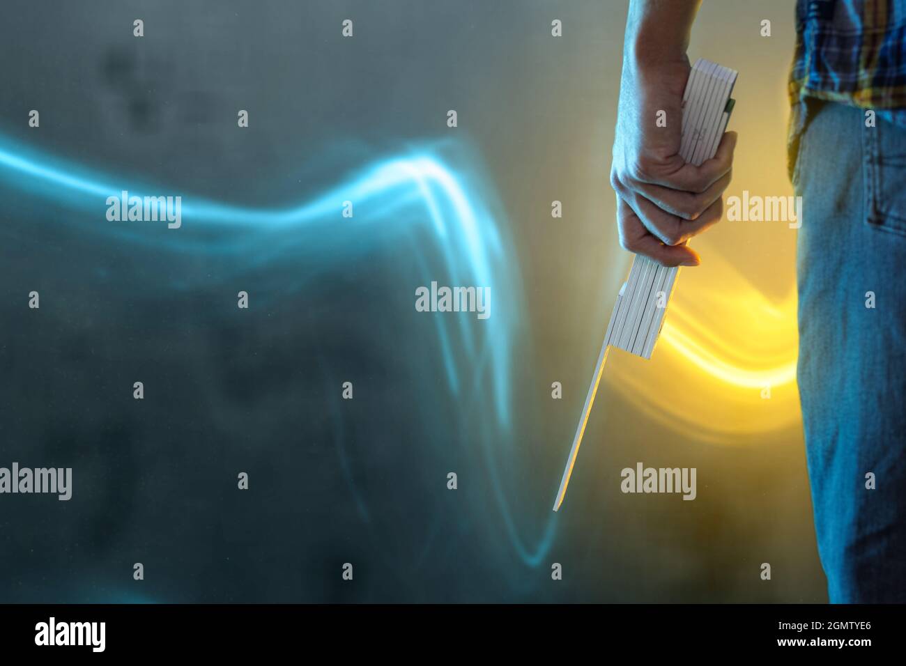 Hand holding a folding rule Stock Photo - Alamy