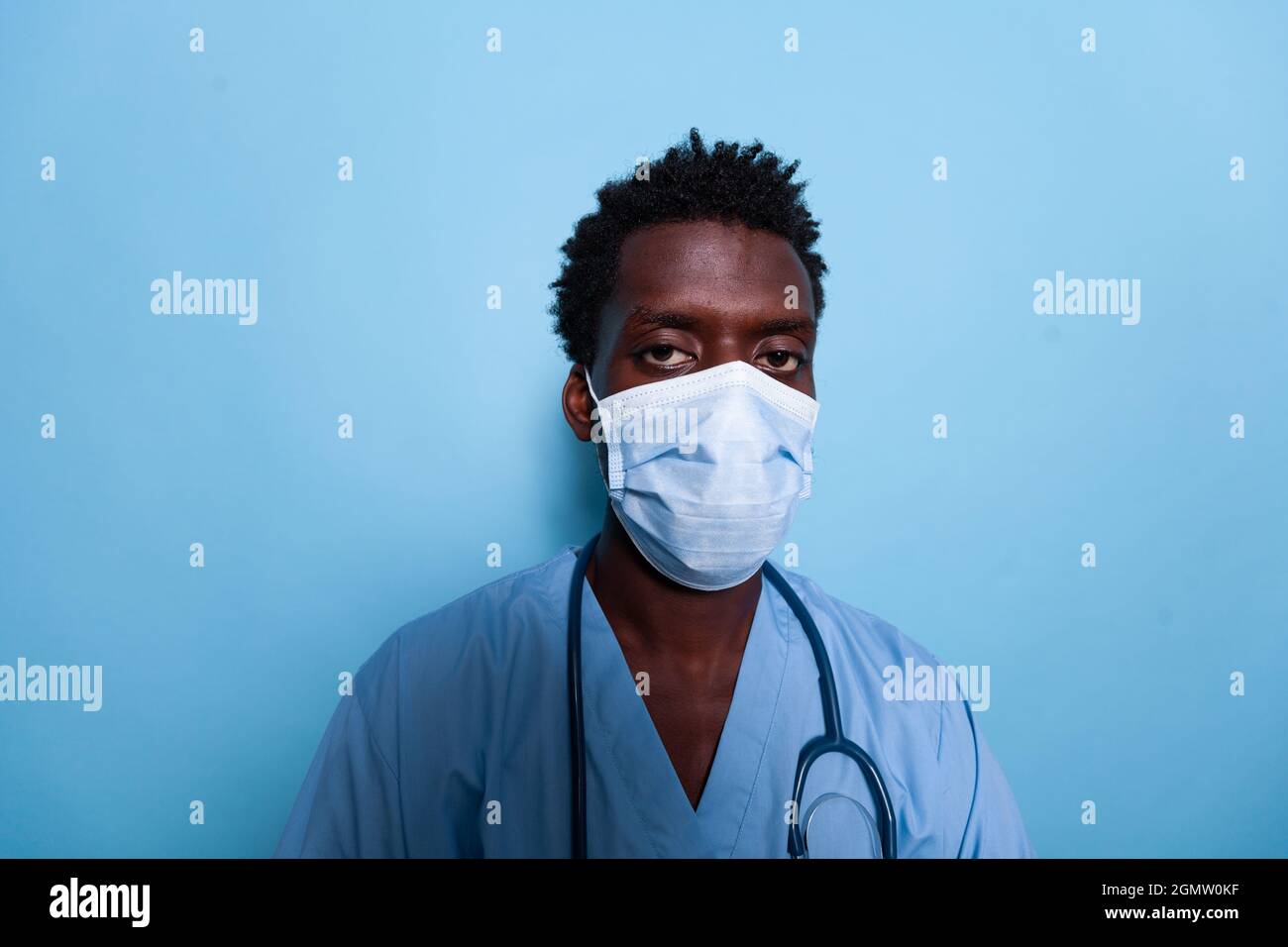 Portrait of black medical assistant wearing face mask and stethoscope ...