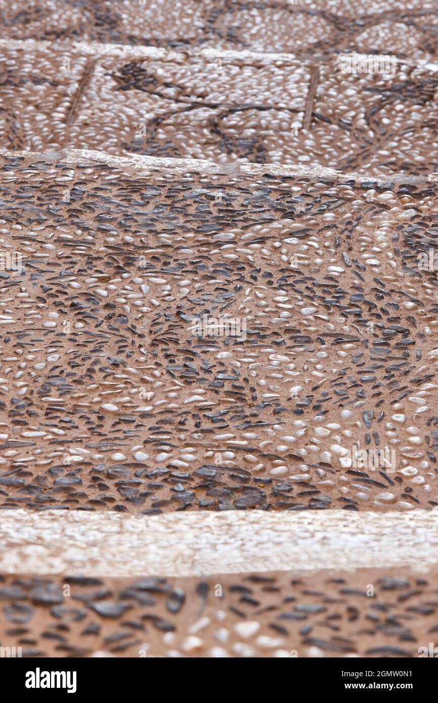 Decorated pebble stone street. Textured pavement sidewalk. Vertical ...