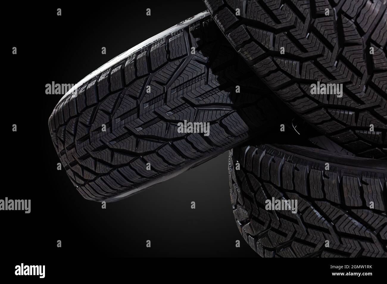 Car tire on black background Stock Photo - Alamy