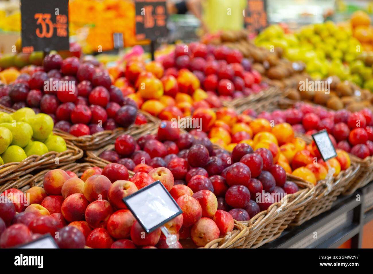 Assortment of fresh fruits on counter in supermarket Stock Photo - Alamy