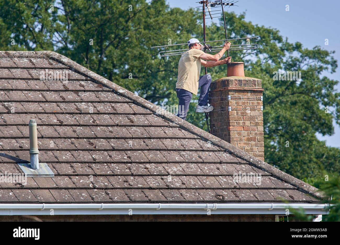 Man on roof hi-res stock photography and images - Alamy