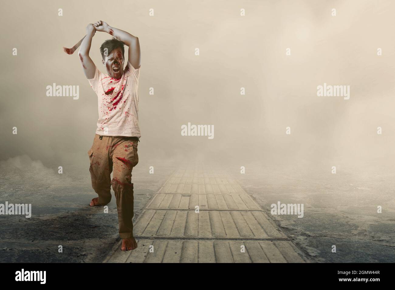 Scary zombie with blood and wound on his body holding sickle walking on ...