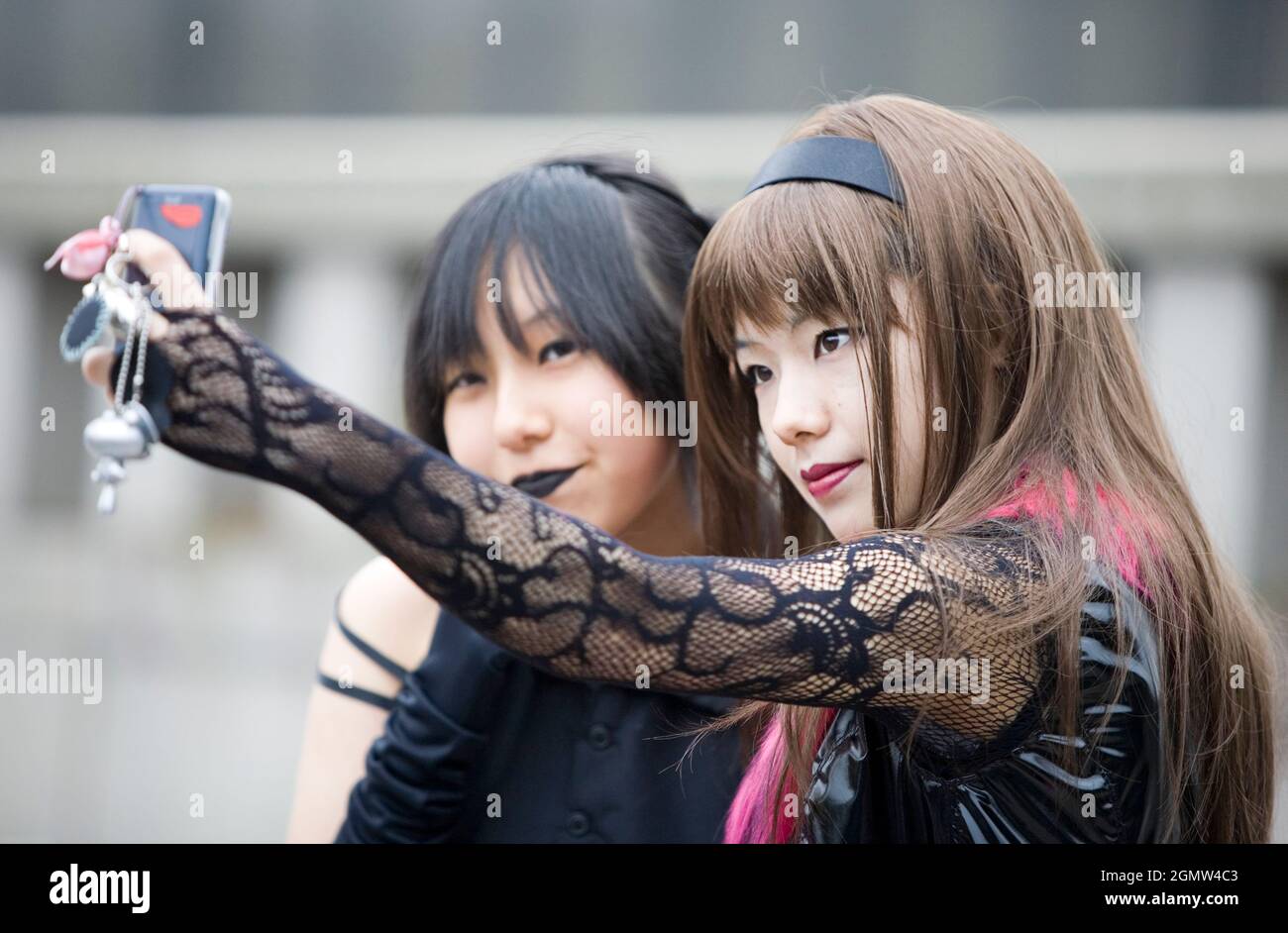 Tokyo, Japan - 6 November 2005; two girls posing in-shot Harajuku is ...