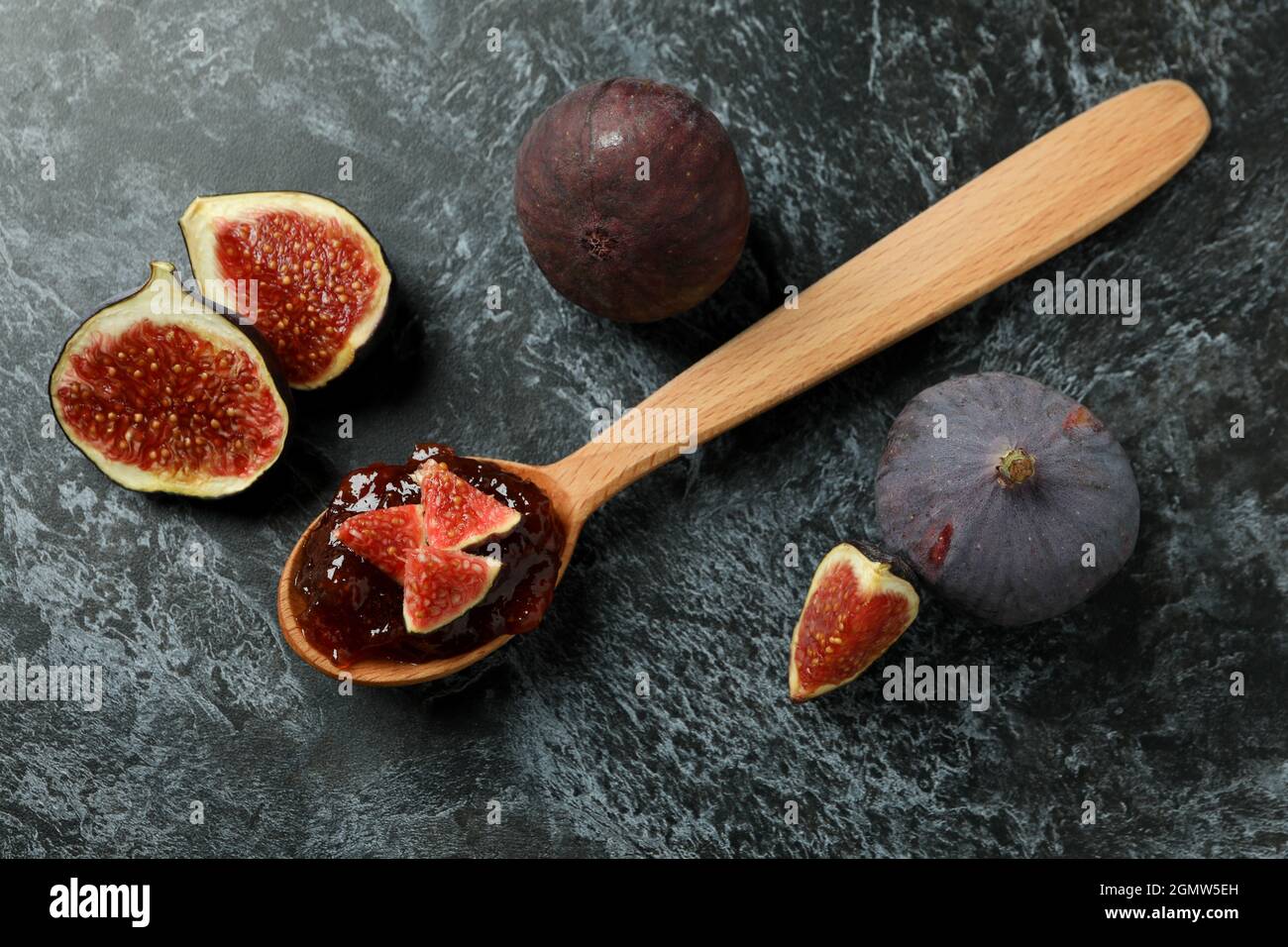 Spoon with fig jam and ingredients on black smokey background Stock ...