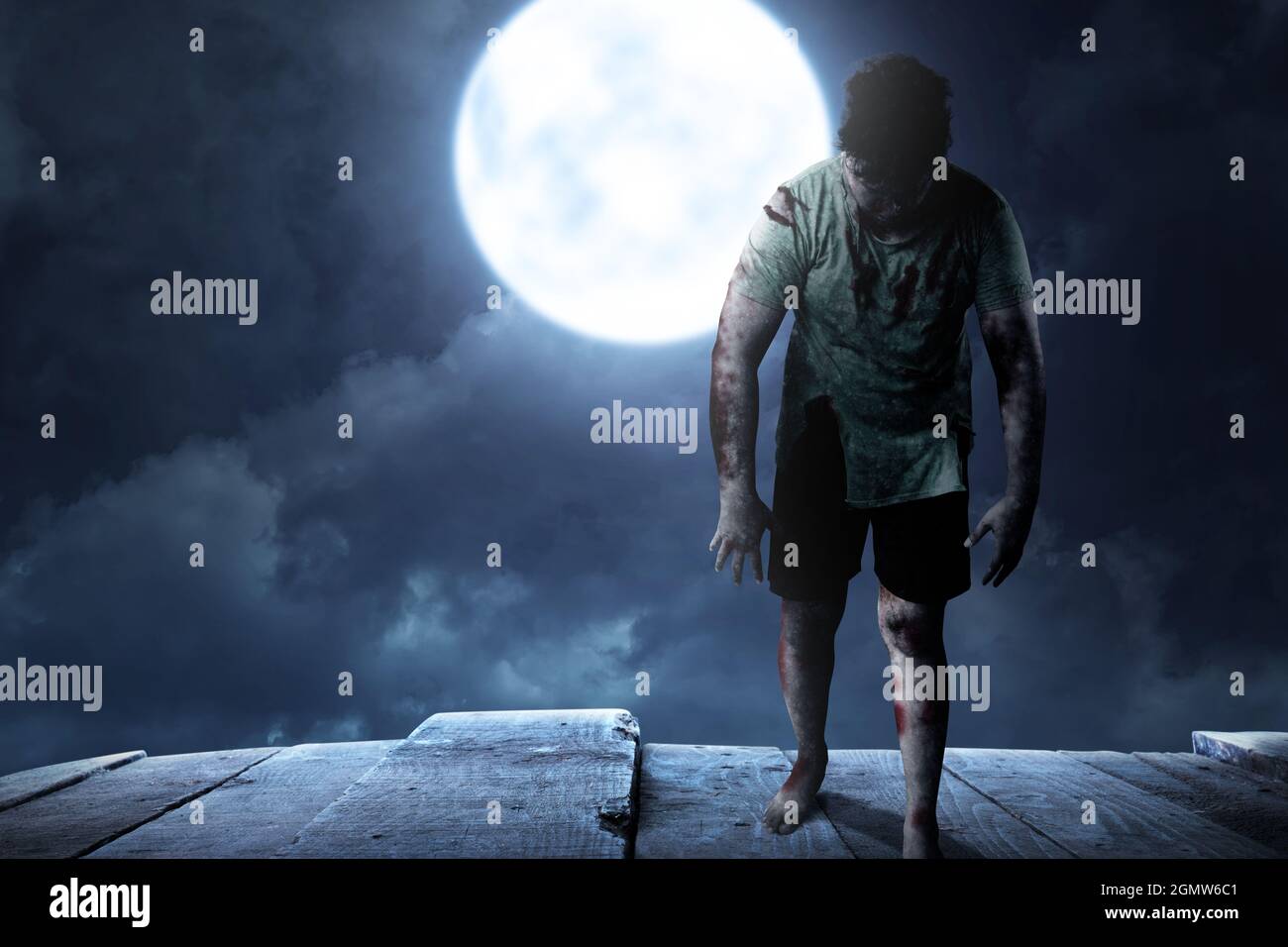 Scary zombie with blood and wound on his body standing with a night ...