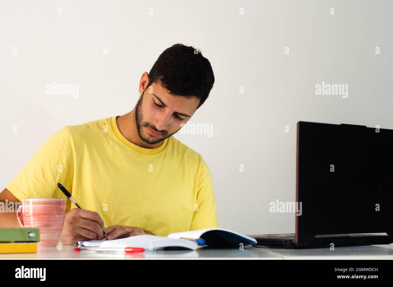 College student doing homework at home. Smart man watching a virtual ...