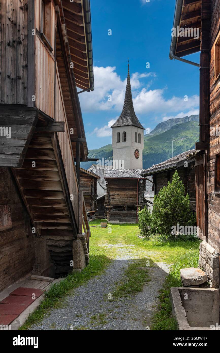 Historic village centre with wooden Valais houses and the tower of the ...