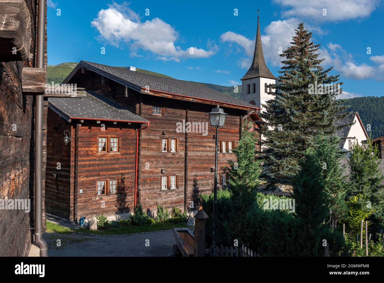 Historic village centre with wooden Valais houses and the tower of the ...