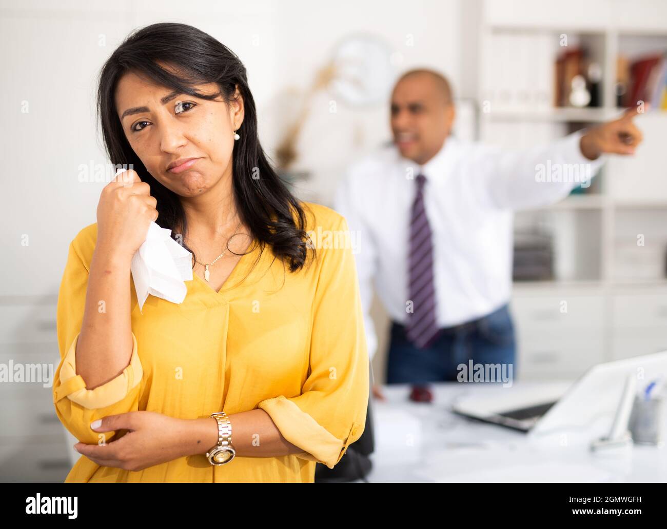Business woman crying standing in office with director behind Stock ...