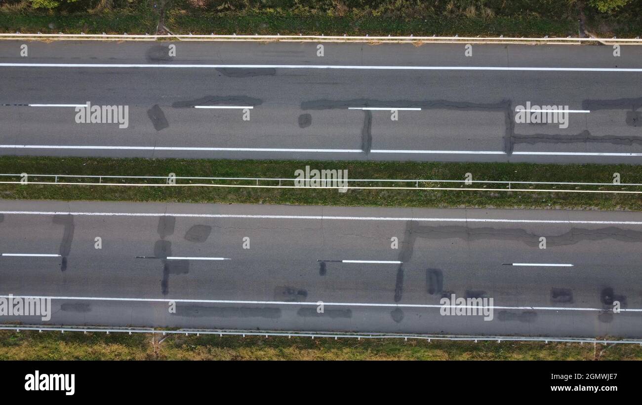 Top view of the highway with patches and repaired areas. Damaged ...