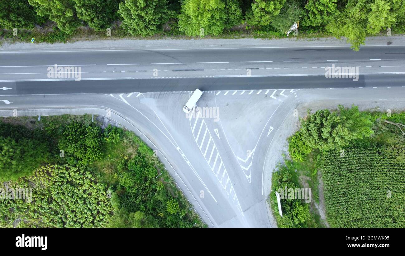 Top view on the intersection of roads in the green area Stock Photo - Alamy