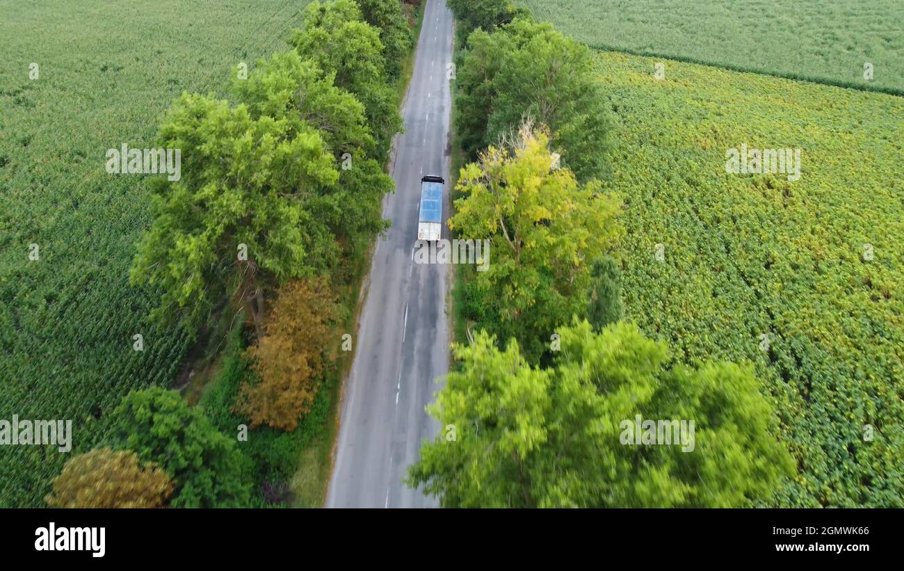The movement of the truck on the asphalted country road, flight over ...