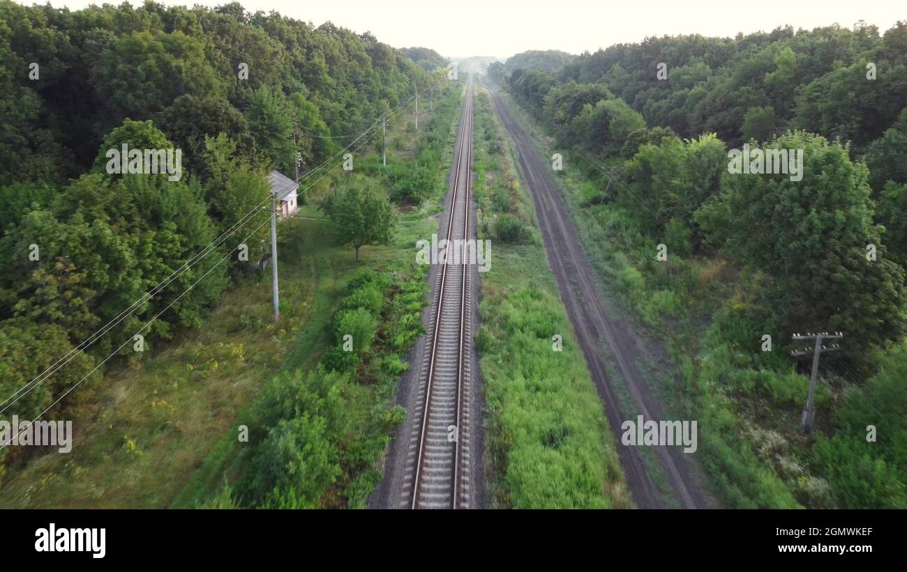 Railway tracks through forests and fields. Transport connection for ...