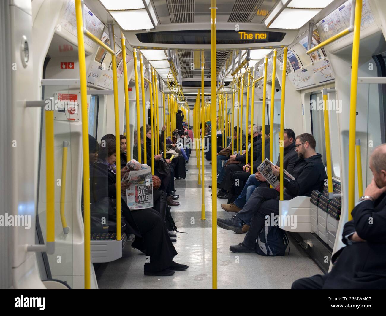 London, England - group of sitting commuters in the London Underground ...
