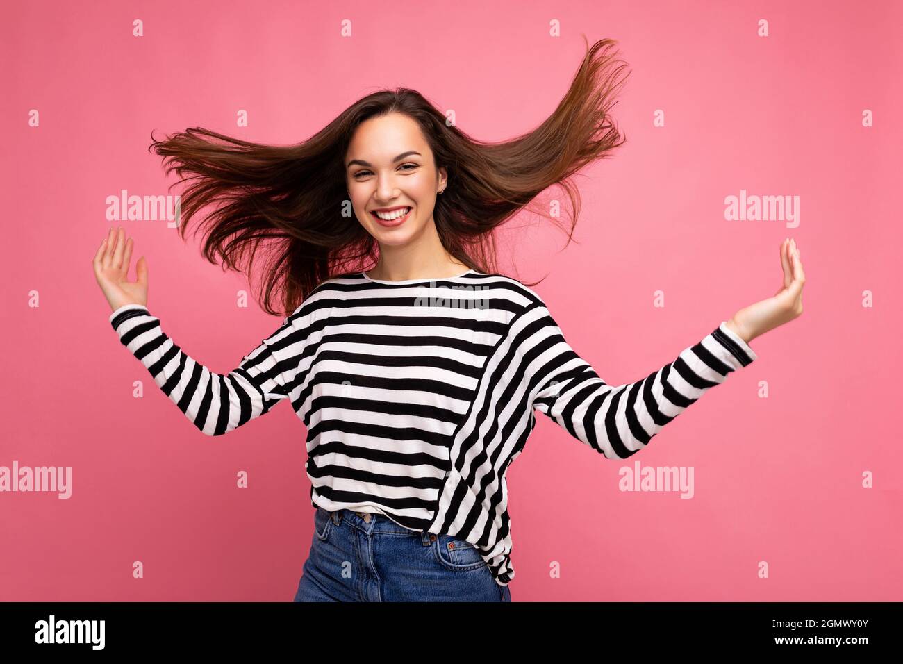 Young beautiful brunet woman. Trendy lady in casual striped longsleeve ...