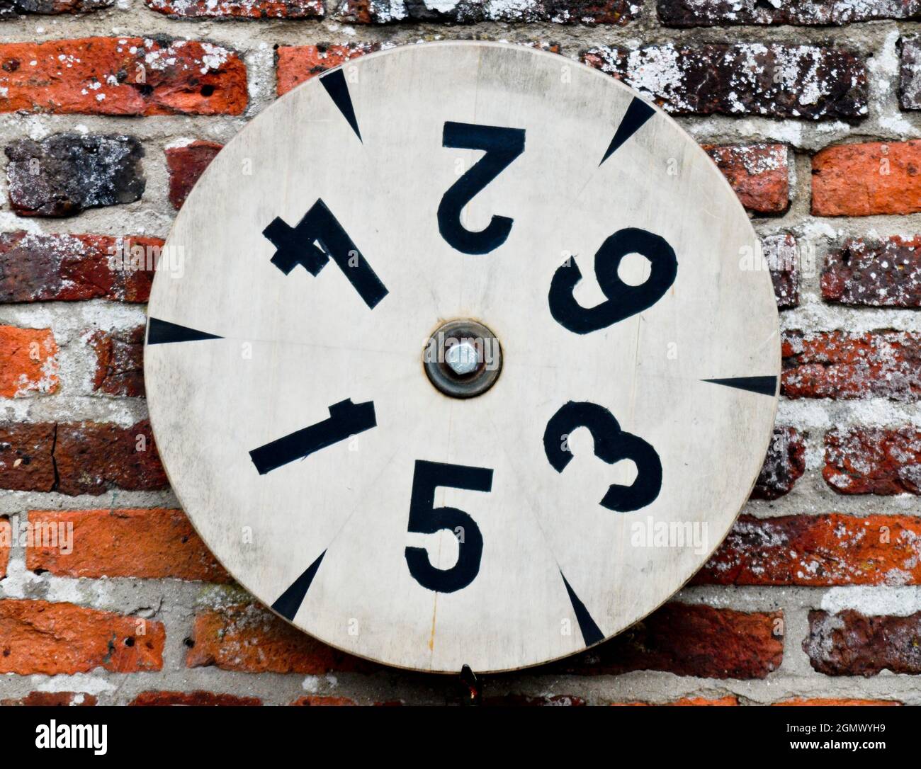 Spinning number wheel on an old rustic brick wall Stock Photo - Alamy