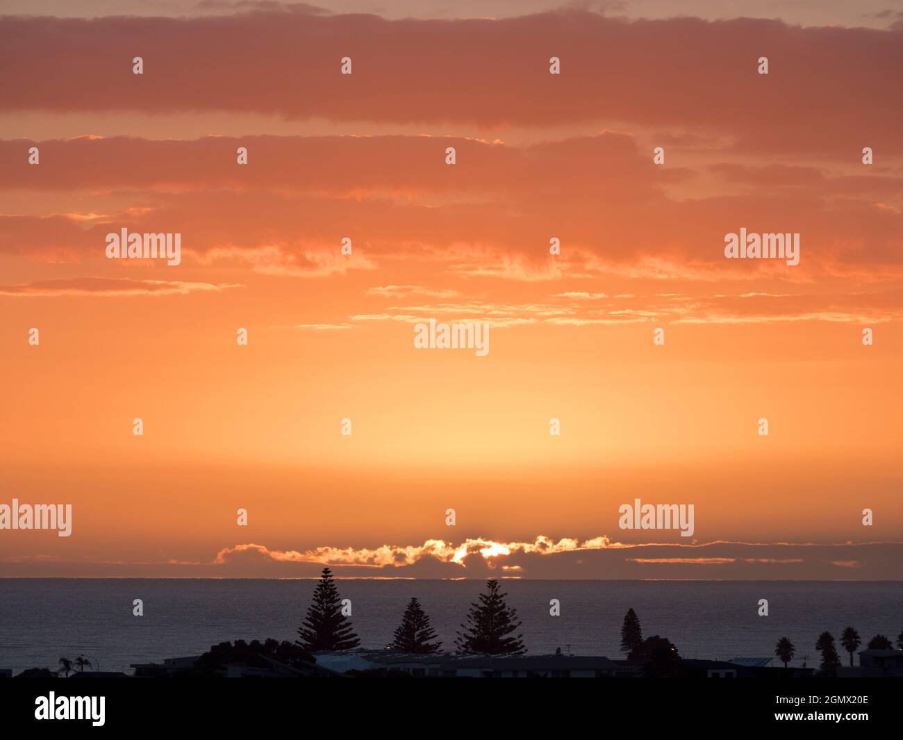 Tauranga, New Zealand - 1 March 2019 A luminous, golden sunrise over ...